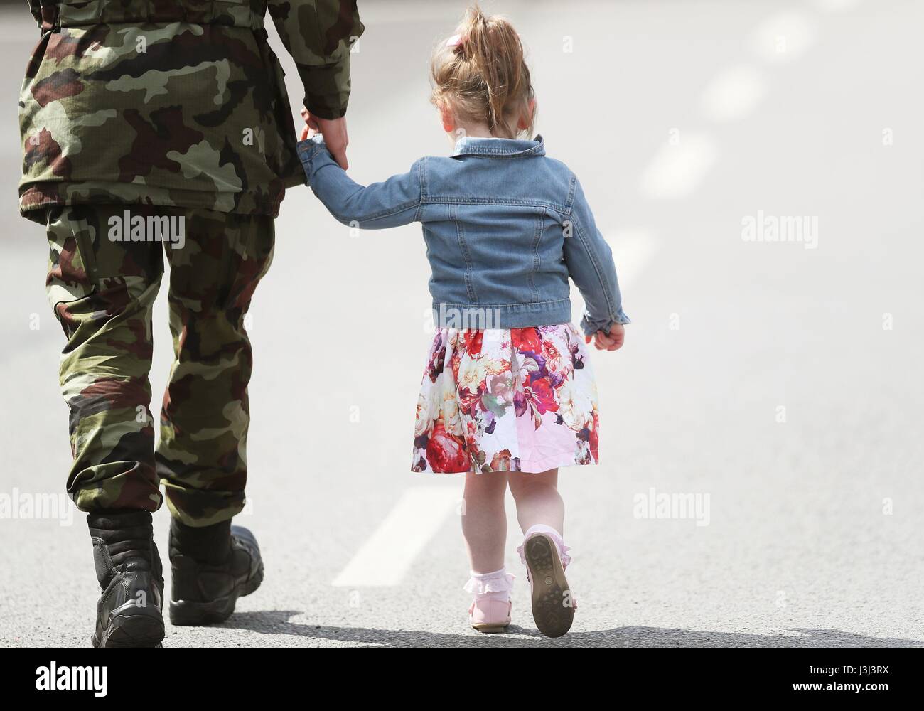Private Daniel Crofton holds the hand of his daughter Amber Kelly ...