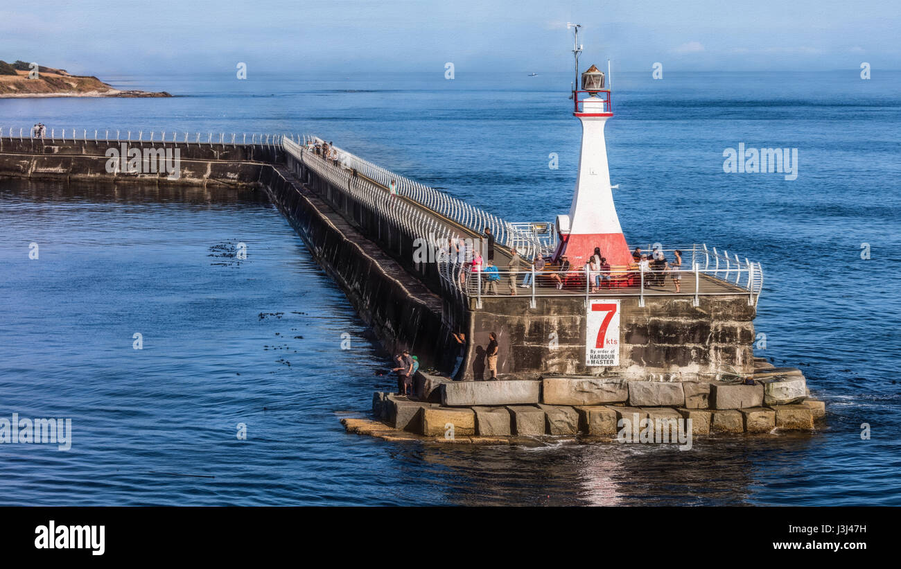 Tourists exploring Ogden Point Lighthouse and Breakwater at Victoria ...