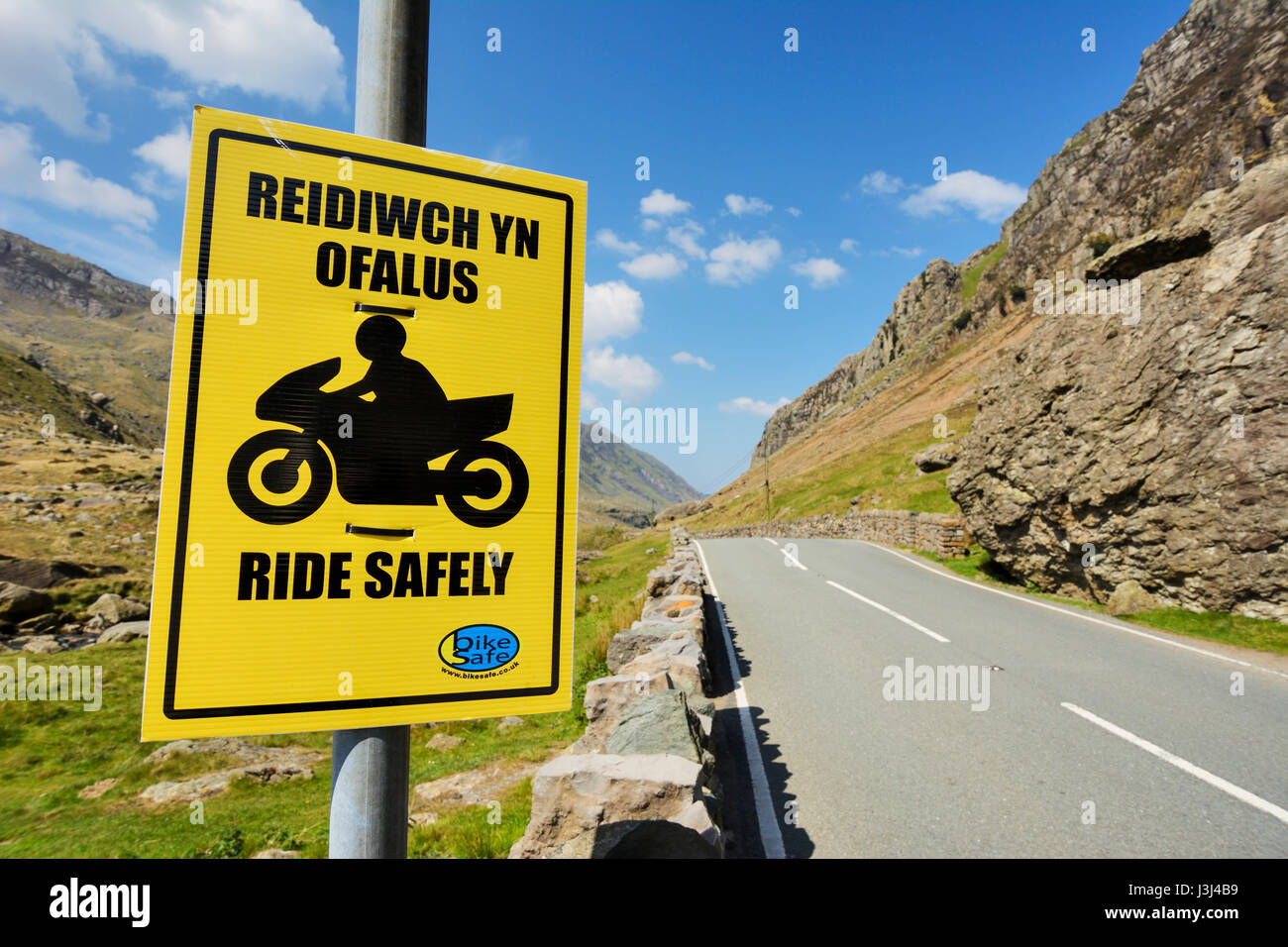 Bright yellow notice attached to clearway sign advising motorcyclists ...