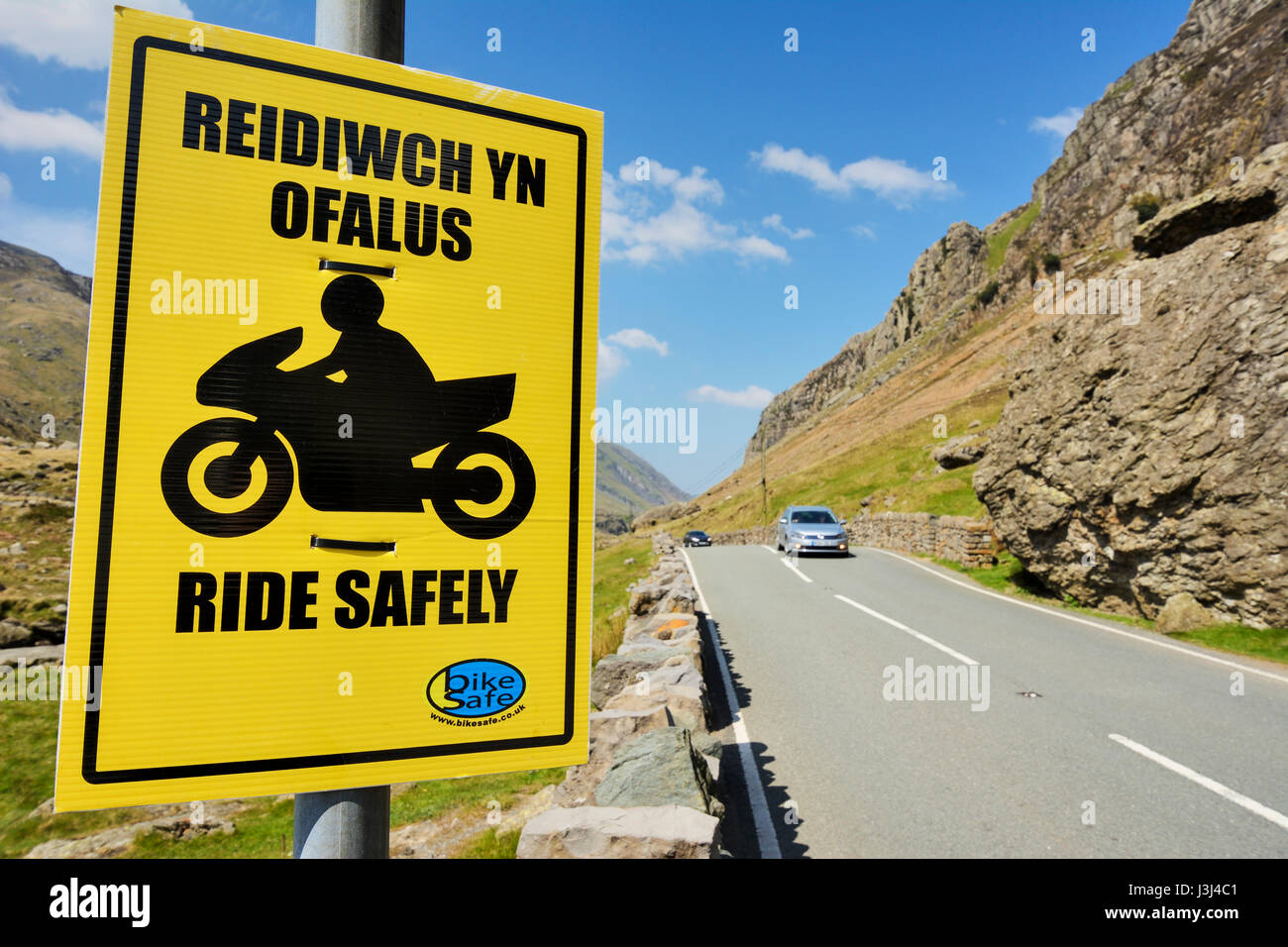 Bright yellow notice attached to clearway sign advising motorcyclists ...