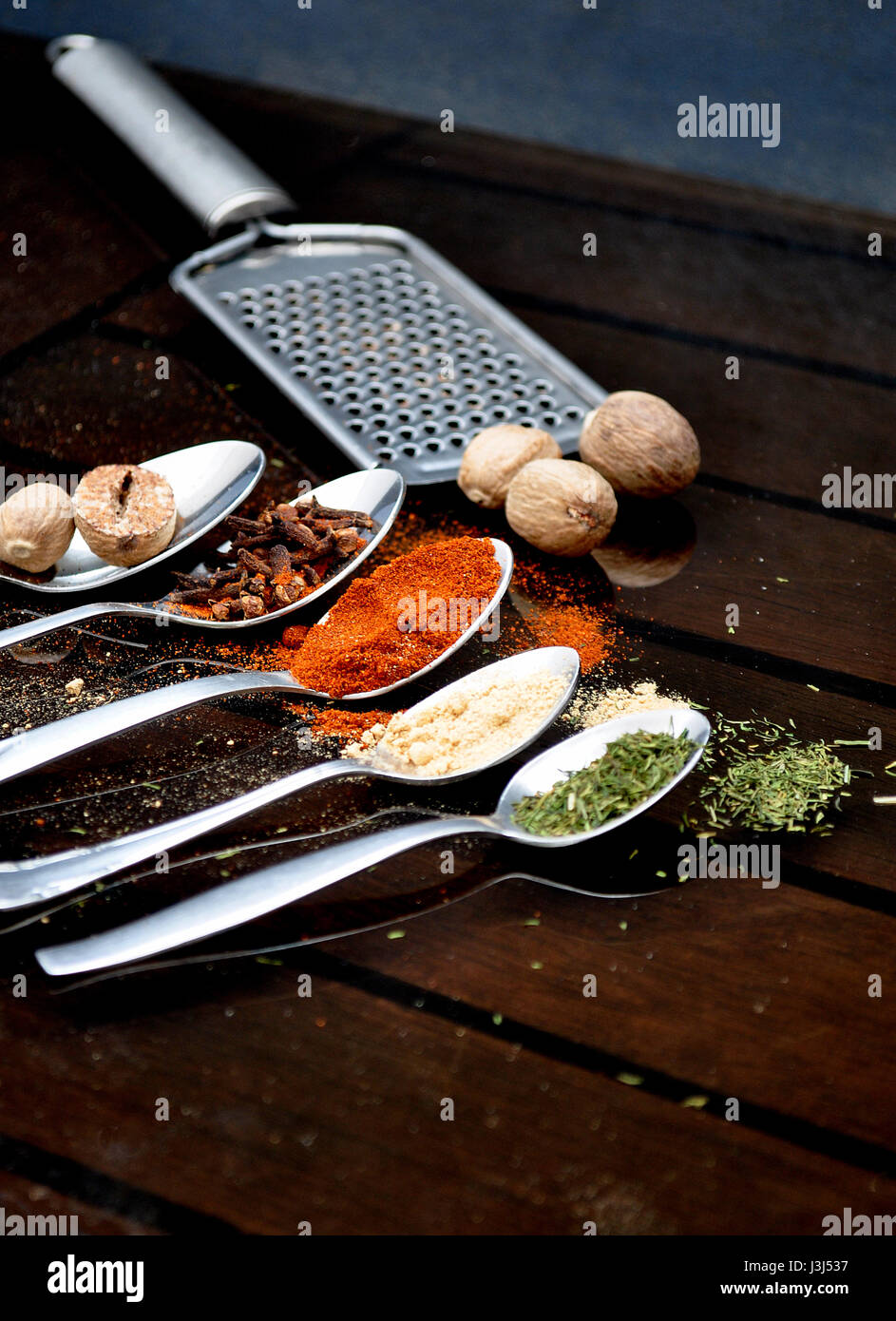 Scraper and spoons with spices in rustic still life Stock Photo - Alamy
