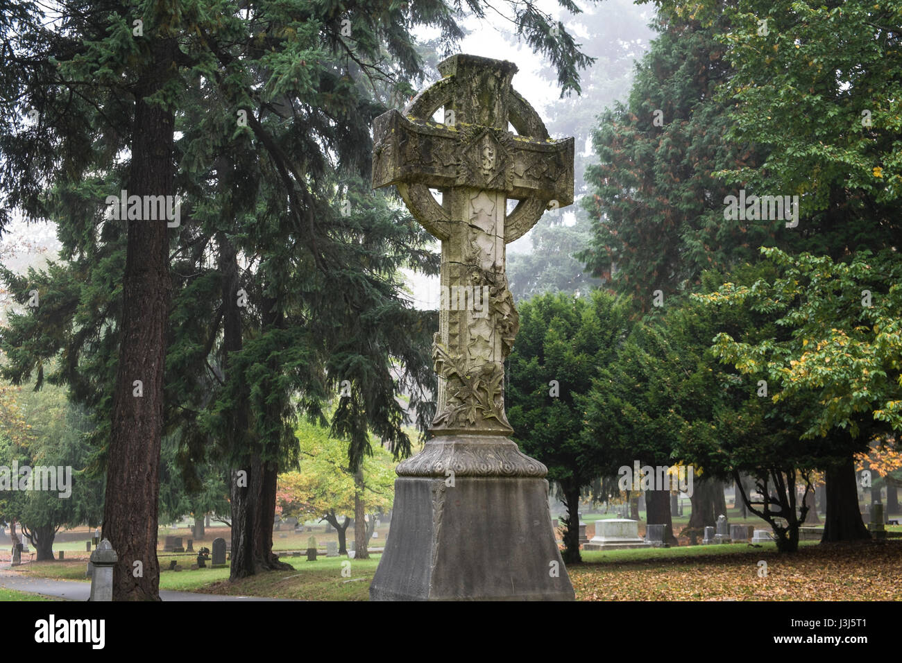 Large statue of a cross in an old Pioneer Cemetery Stock Photo - Alamy