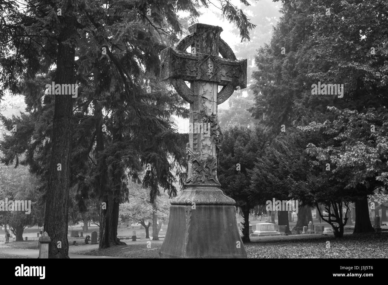 Large statue of a cross in an old Pioneer Cemetery Stock Photo - Alamy