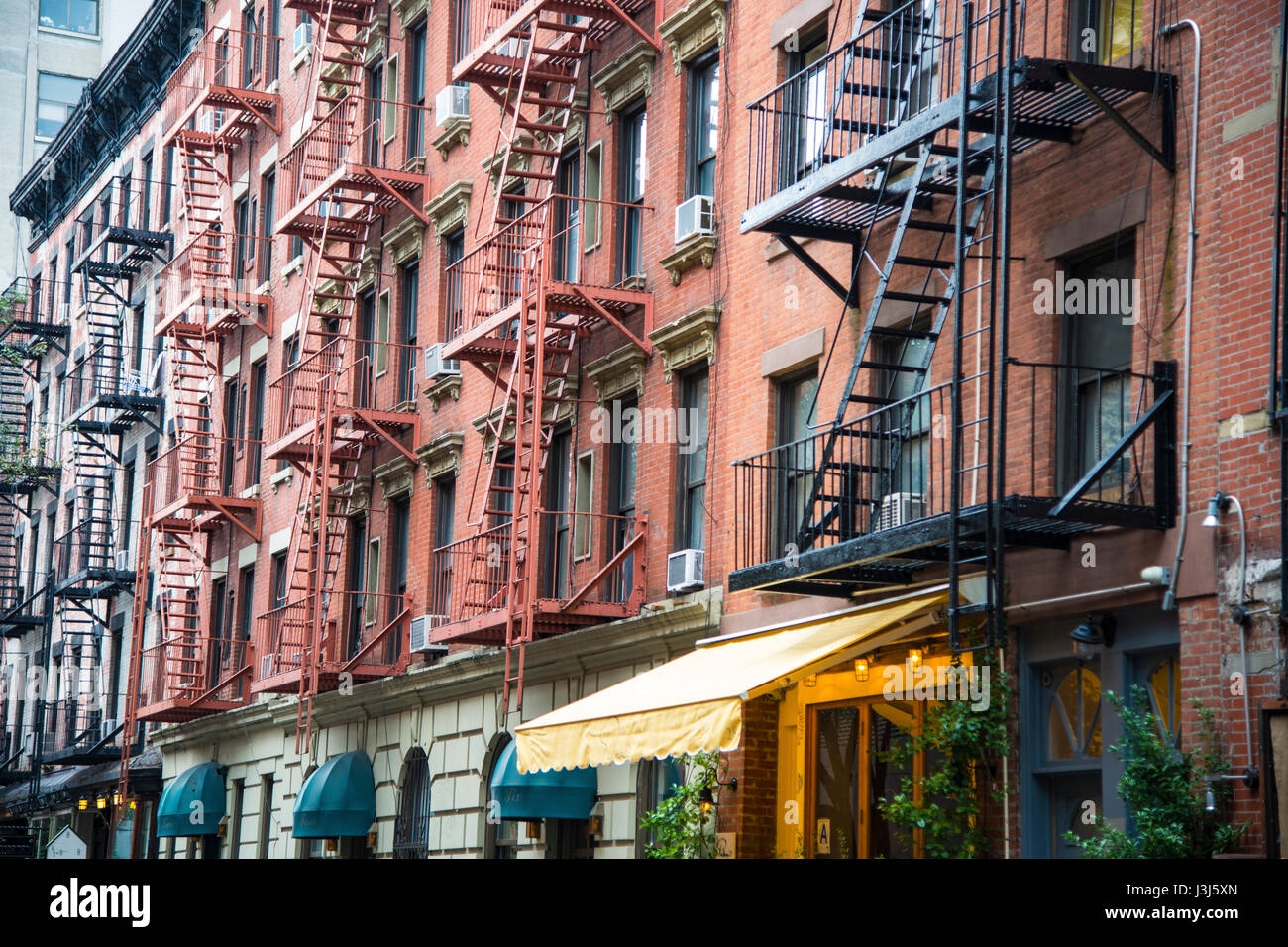 Red brick apartment building with fire escape in New York city Stock ...