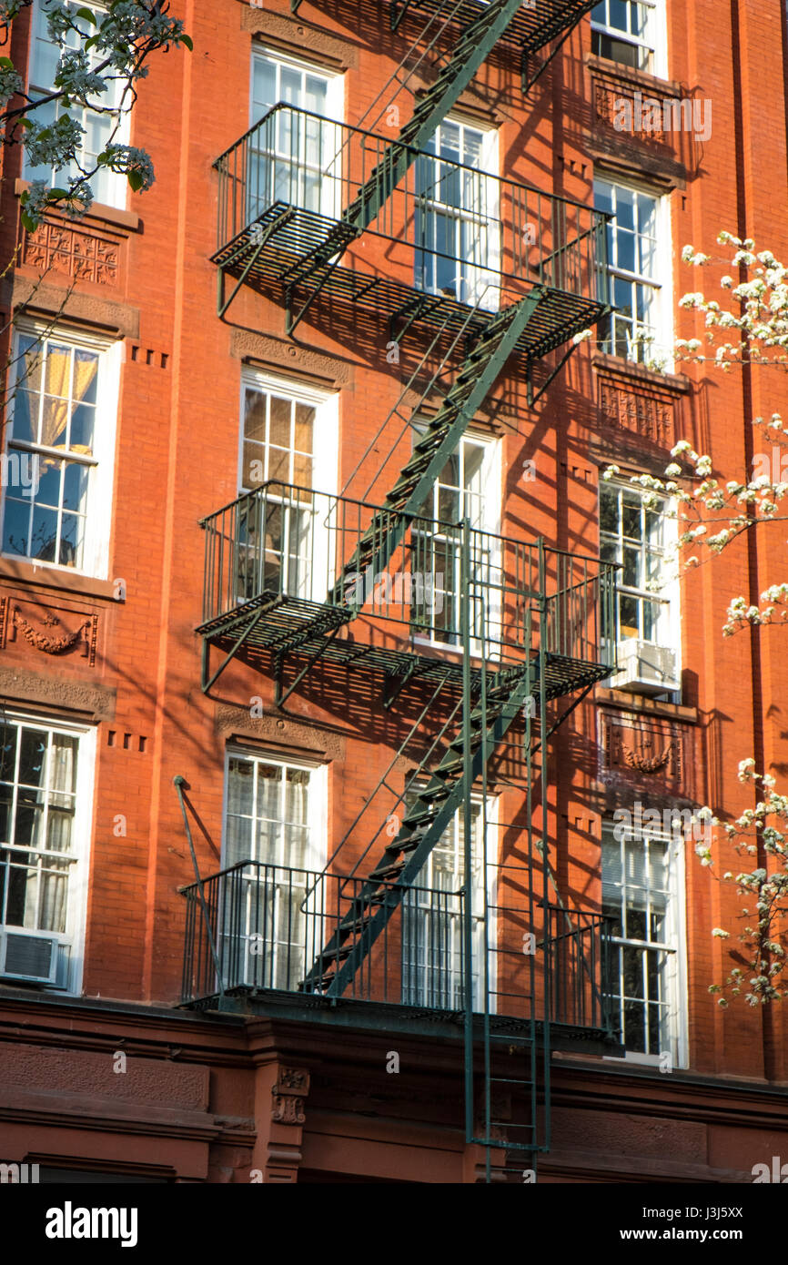 Red brick apartment building with fire escape in New York city Stock ...