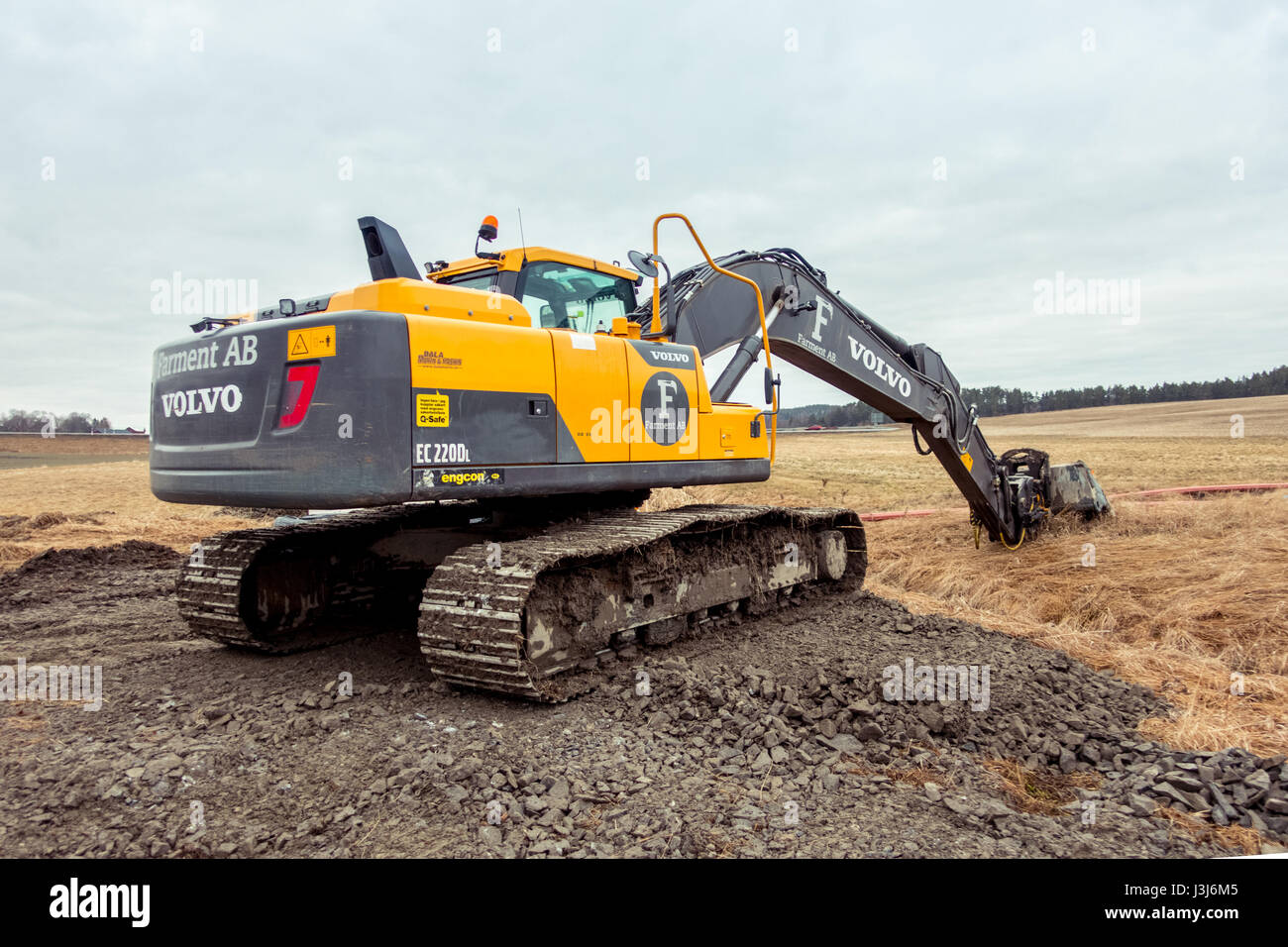 excavator is digging up mud Stock Photo - Alamy