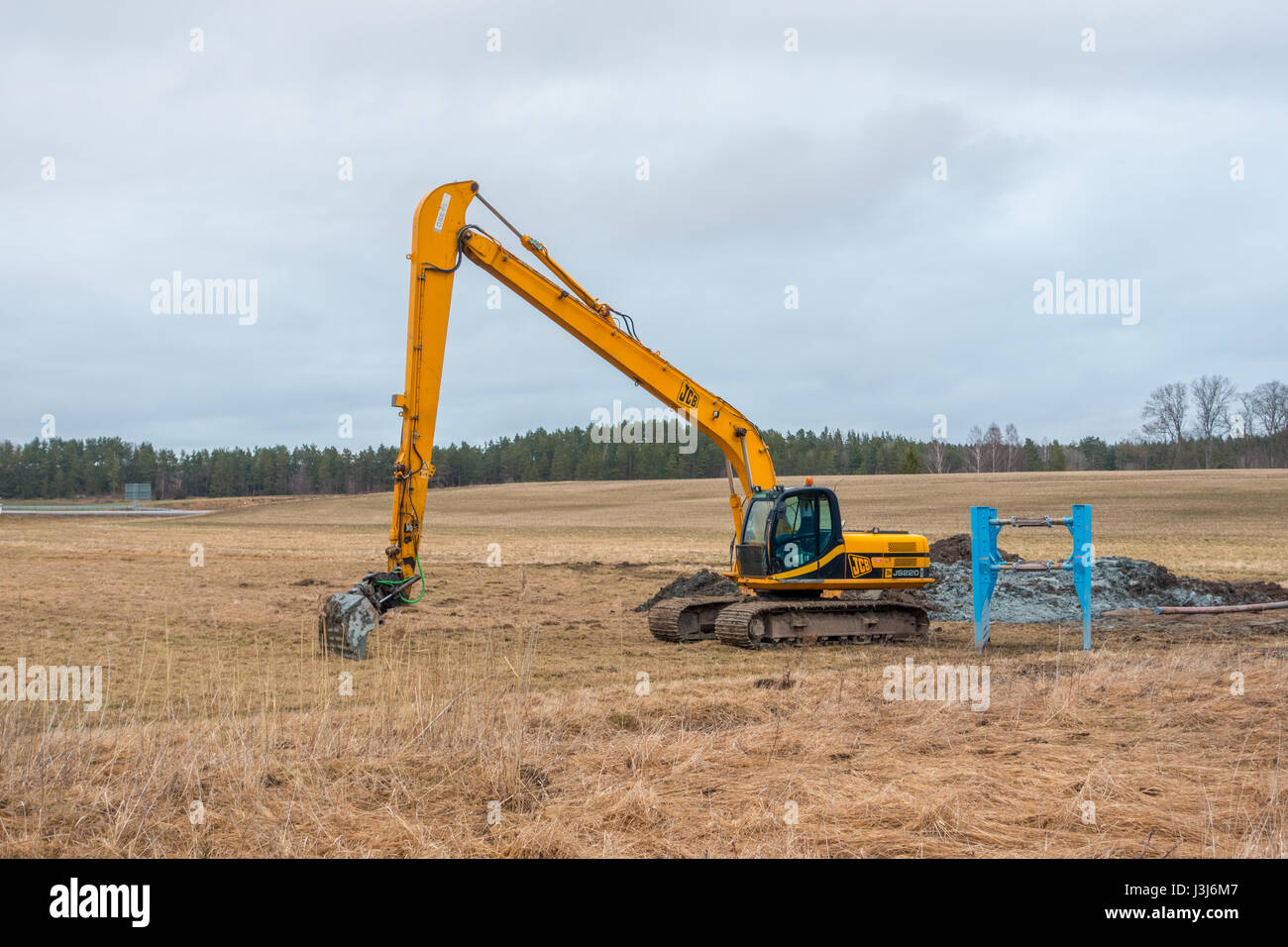 long reach excavator on a dig site Stock Photo - Alamy