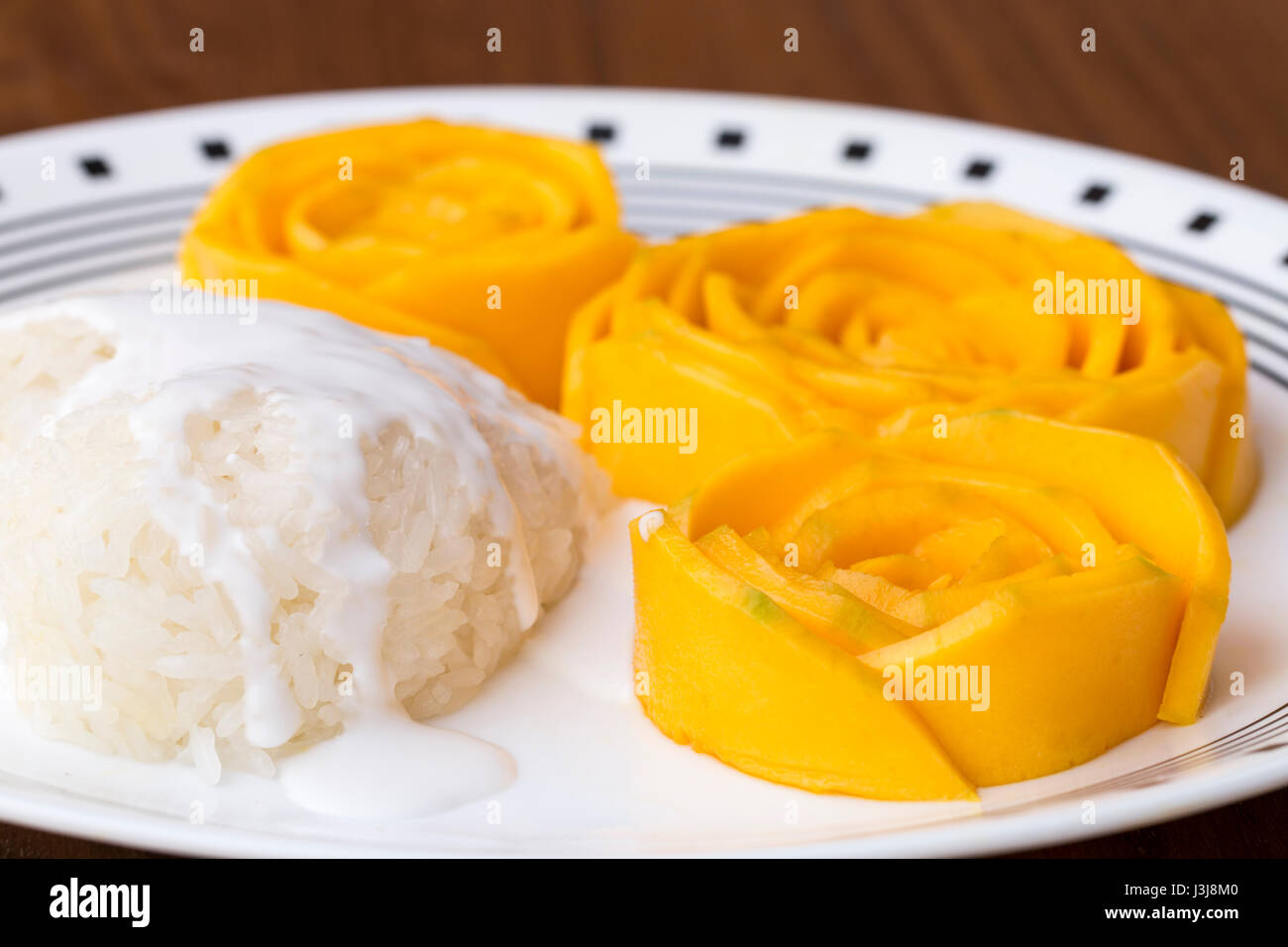 Mango with sticky rice mix with coconut milk on wooden table , Thai ...