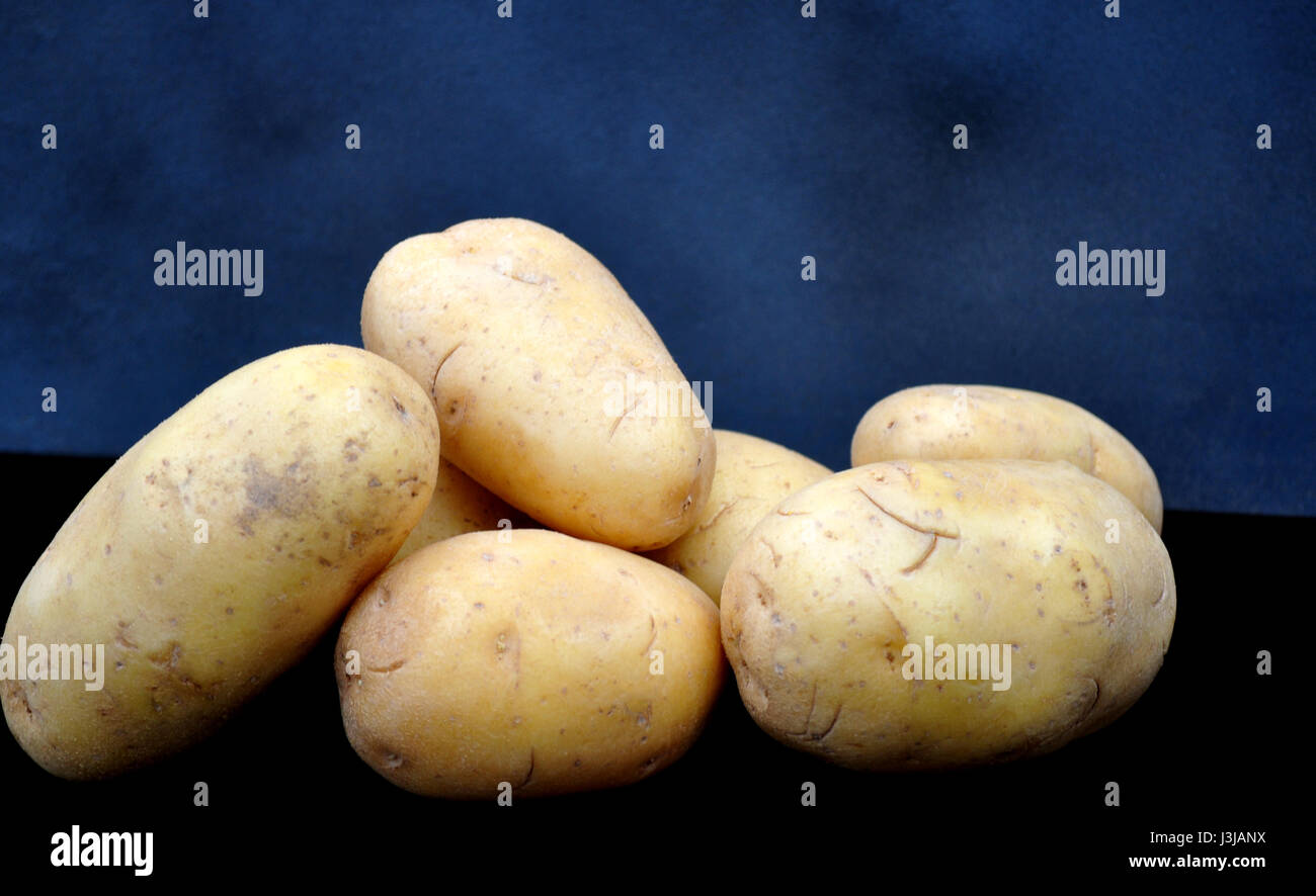 Seven Potatoes in dark environment Stock Photo - Alamy