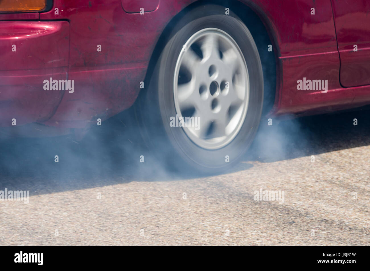Rear wheel drive car burning tire for warm up Stock Photo - Alamy