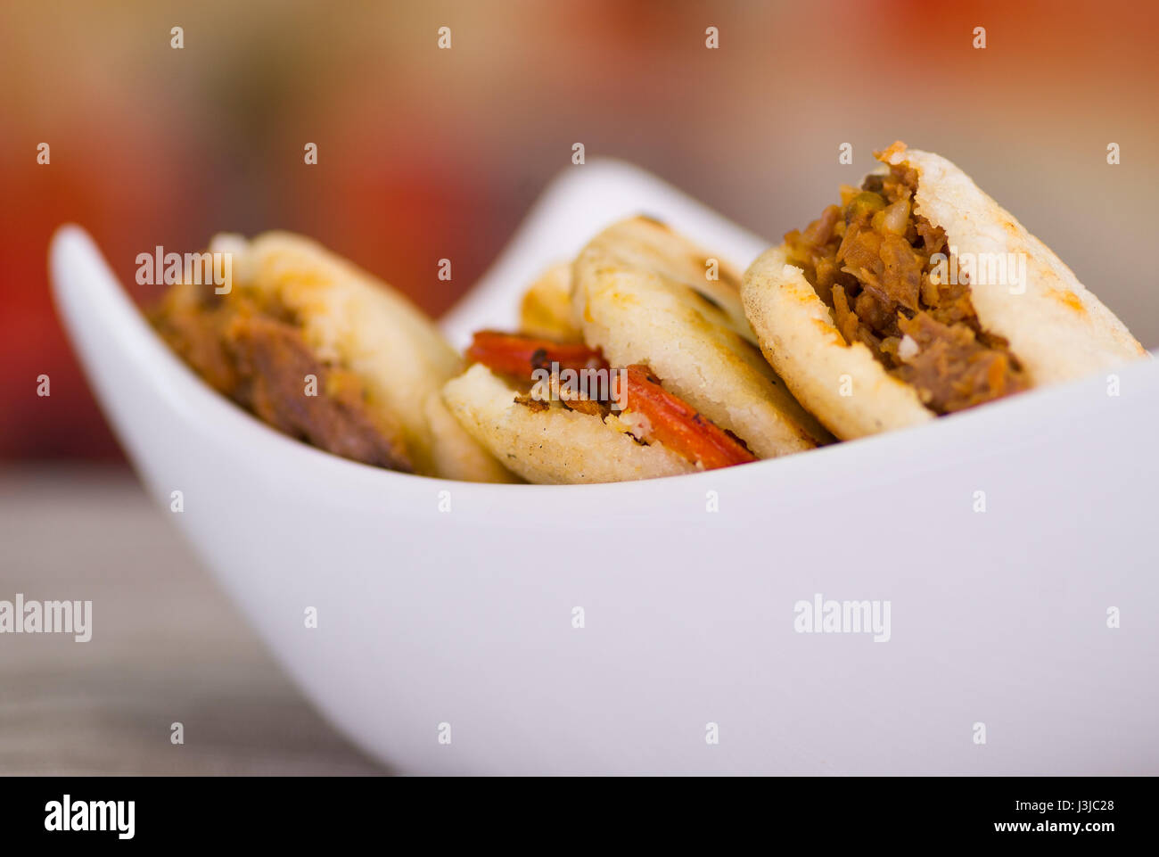 Close up of a traditional delicious arepas, shredded chicken avocado ...