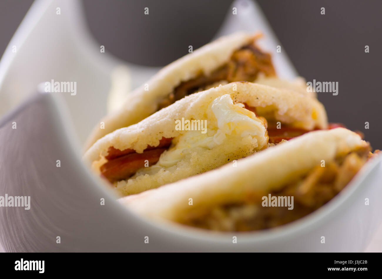 Close up of a traditional delicious arepas, shredded chicken avocado ...