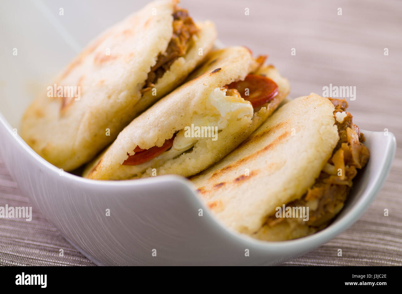 Close up of a traditional delicious arepas, shredded chicken avocado ...