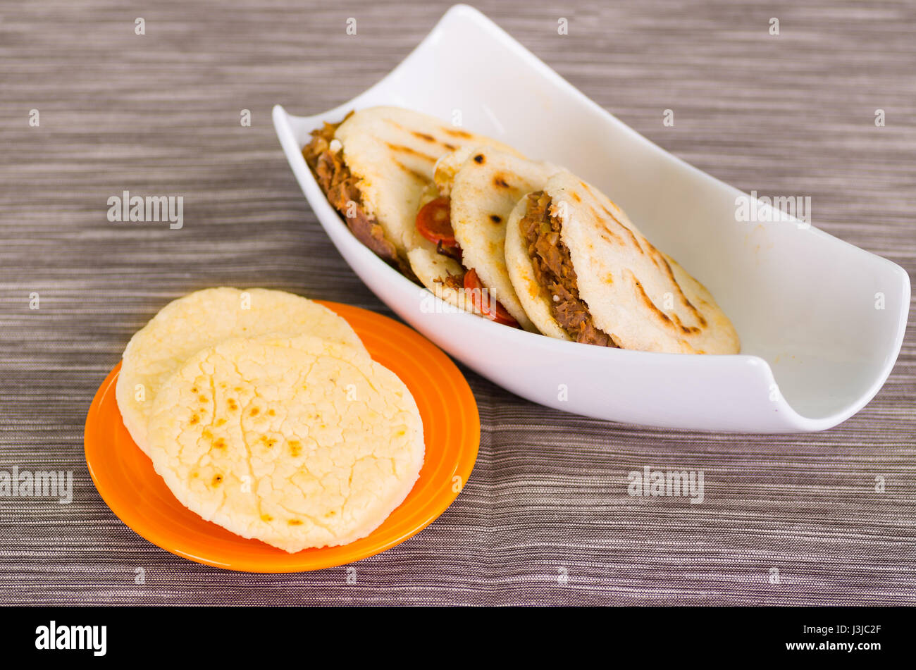 Traditional delicious arepas, shredded chicken avocado and cheddar ...