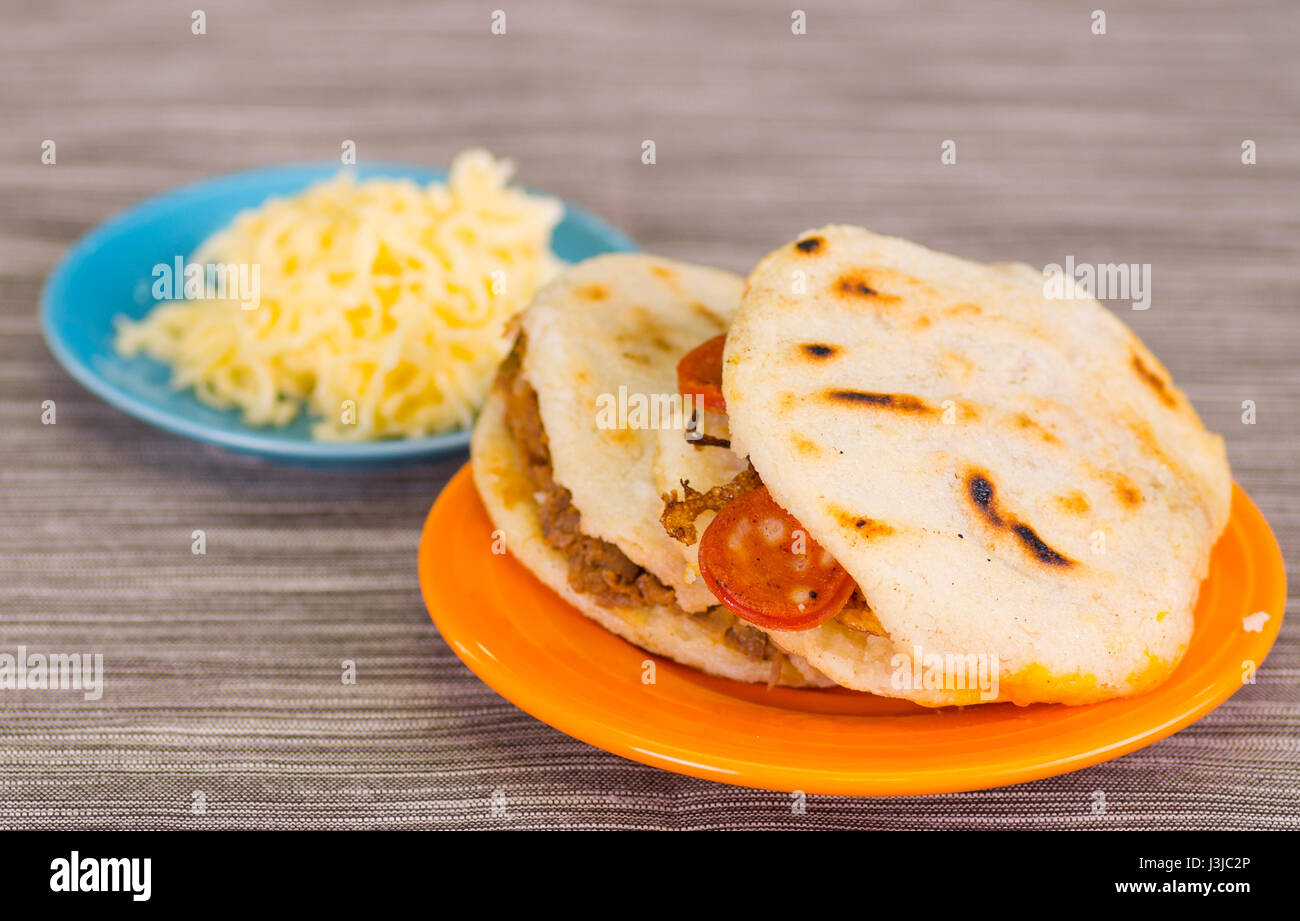 Traditional delicious arepas, shredded chicken avocado and cheddar ...