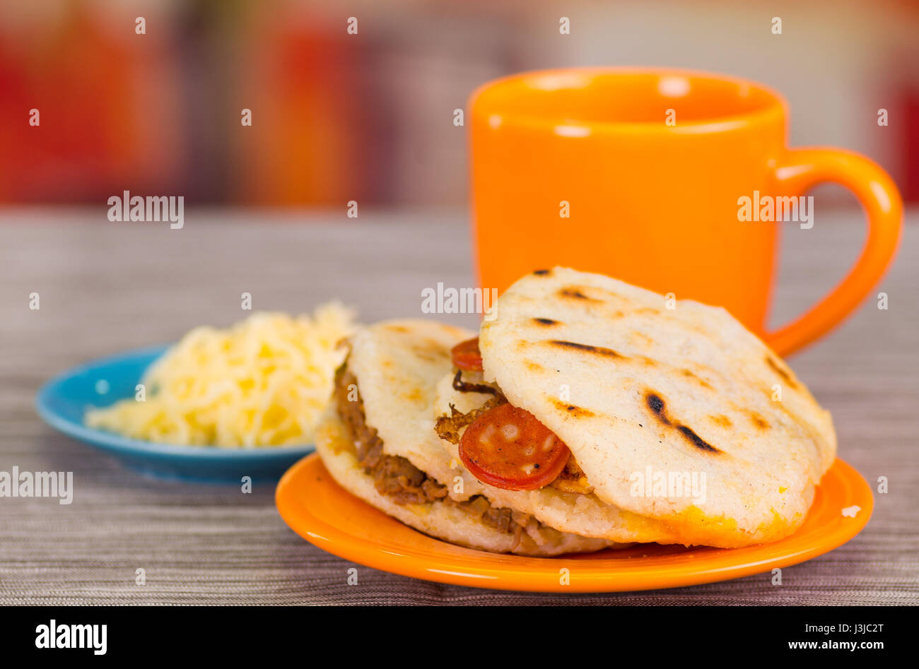 Traditional delicious arepas, shredded chicken avocado and cheddar ...