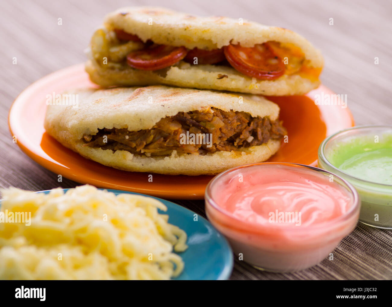 Traditional delicious arepas, shredded chicken avocado and cheddar ...