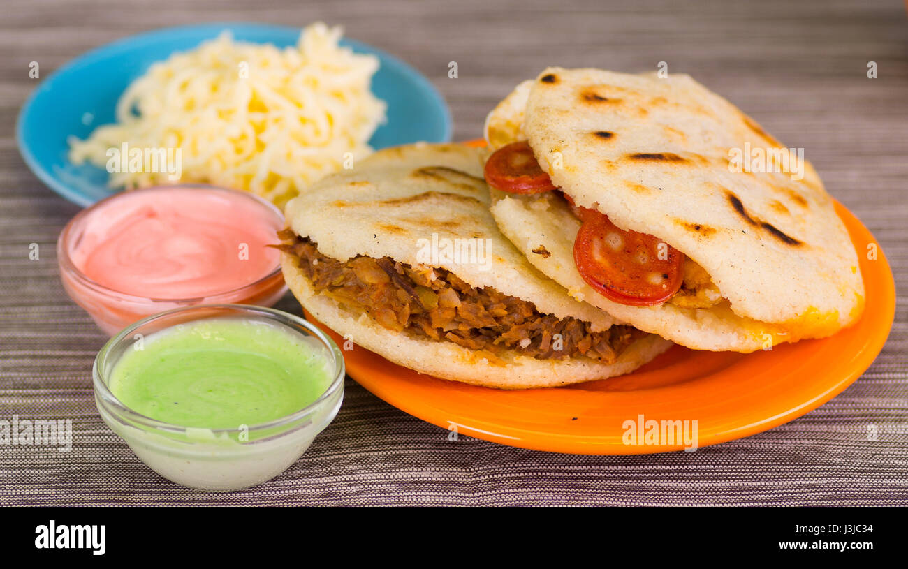 Traditional delicious arepas, shredded chicken avocado and cheddar ...