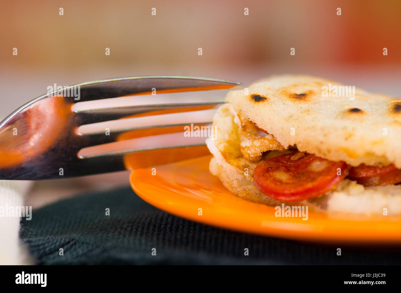 Closeup of a delicious traditional arepas, shredded chicken avocado and ...