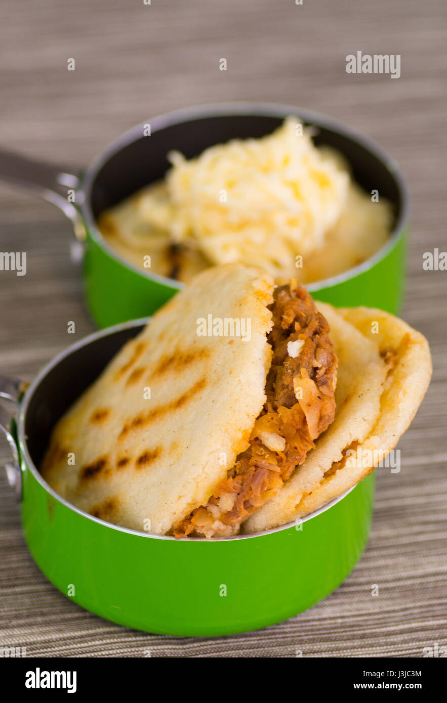 Traditional delicious arepas, shredded chicken avocado and cheddar ...