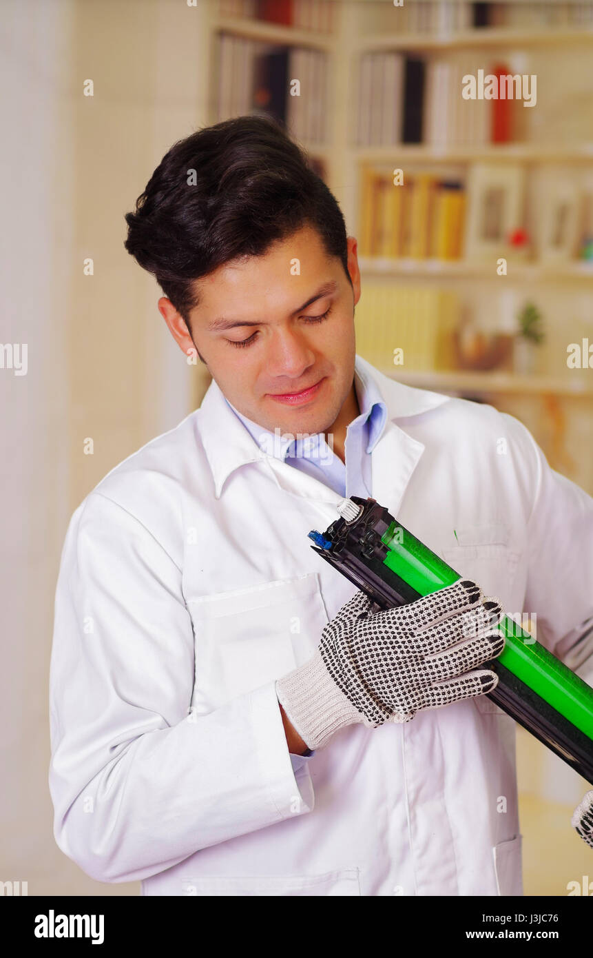 Handsome man holding a toner during maintenance Stock Photo - Alamy