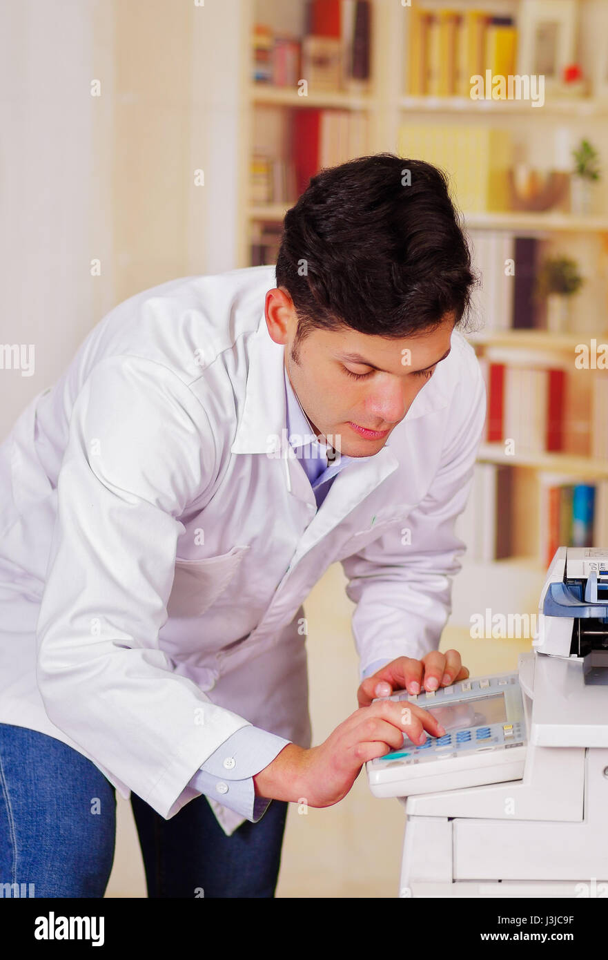 closeup shot young male technician testing digital photocopier machine ...
