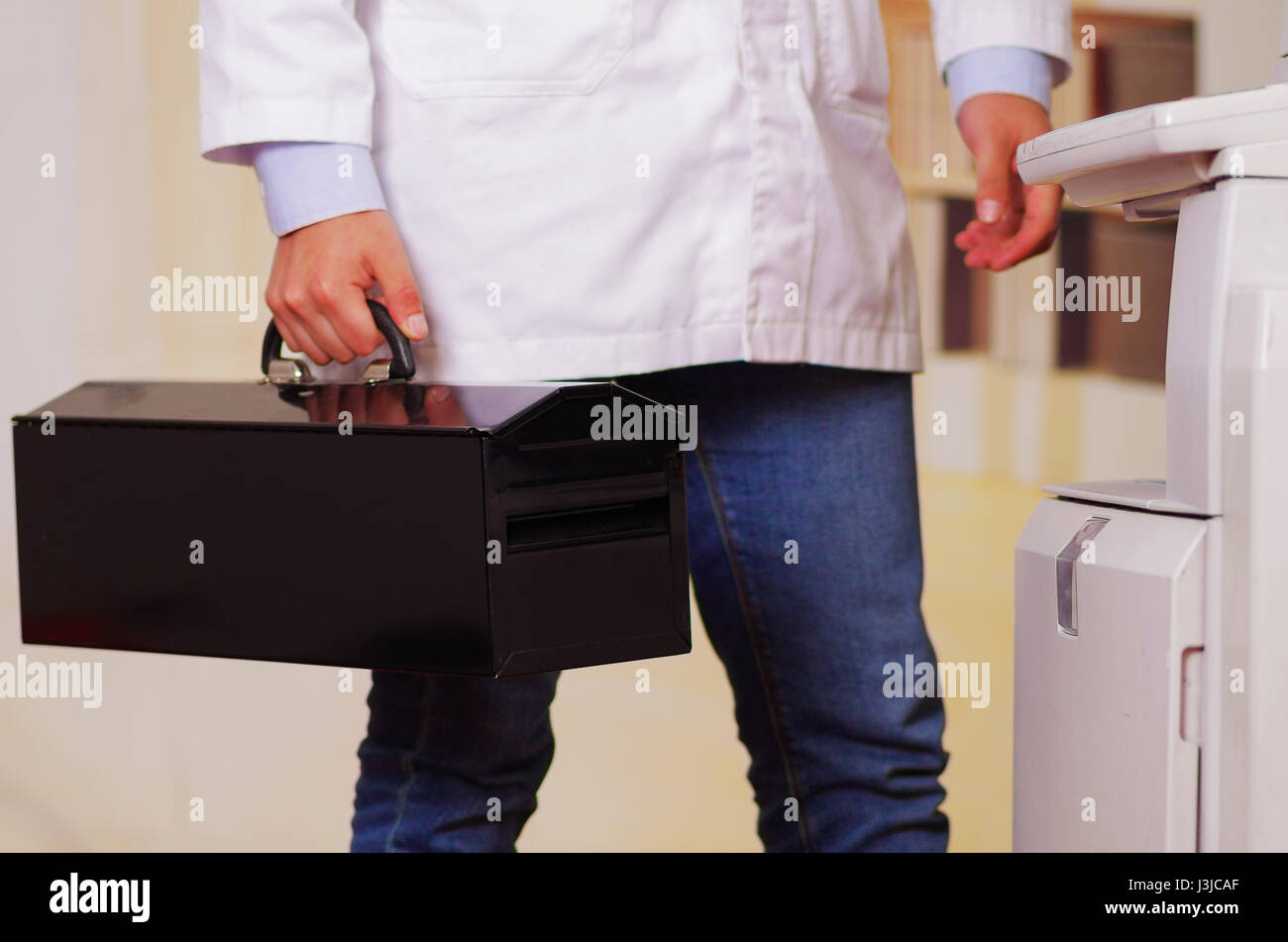 Hardworking Man holding a black tool box Stock Photo - Alamy
