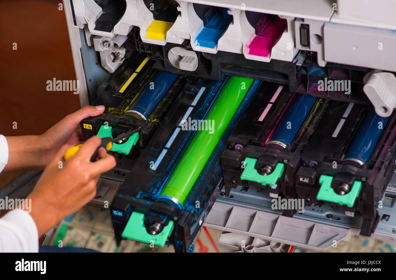 Closeup of a woman fixing a photocopier during maintenance Stock Photo ...