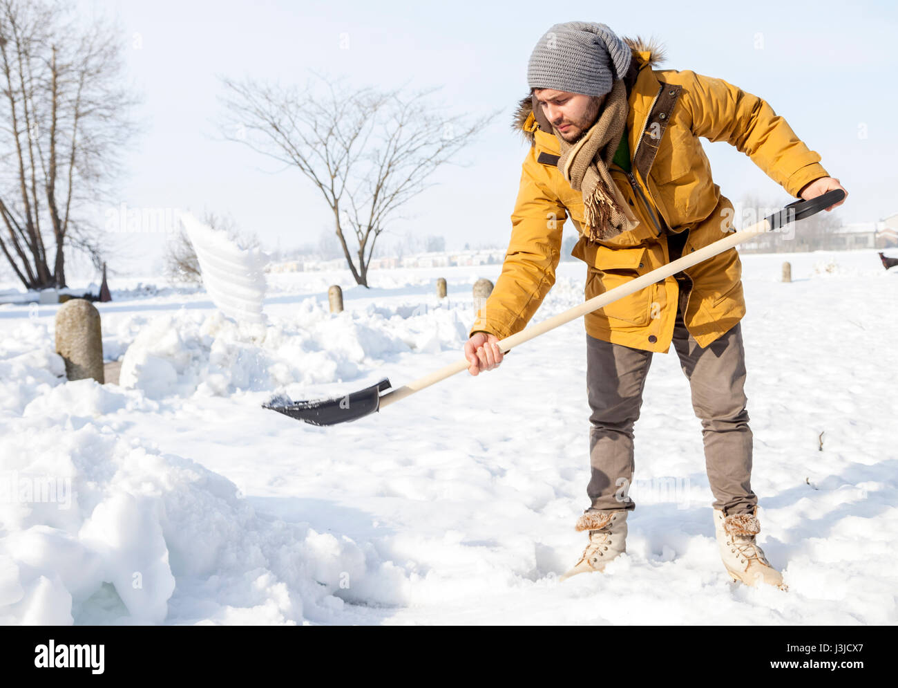 young man shoveling snow in the country Stock Photo - Alamy
