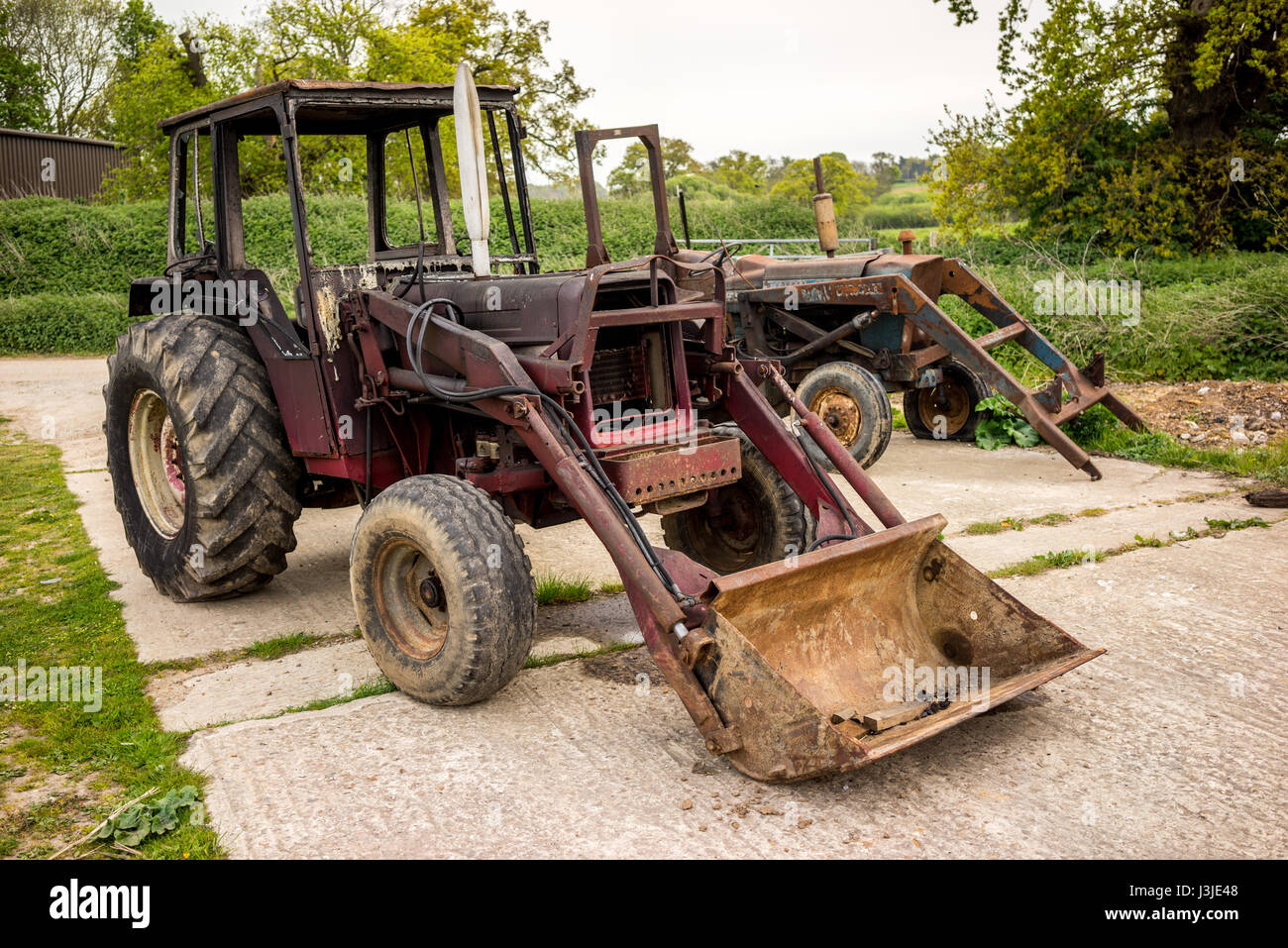 Burnt out old tractor Stock Photo - Alamy