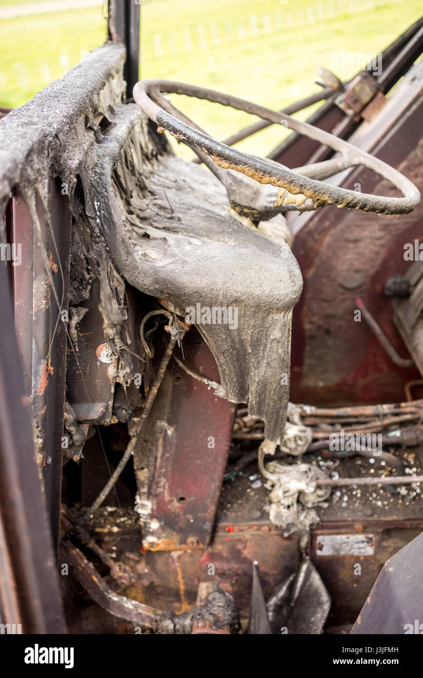 Burnt out old tractor Stock Photo - Alamy
