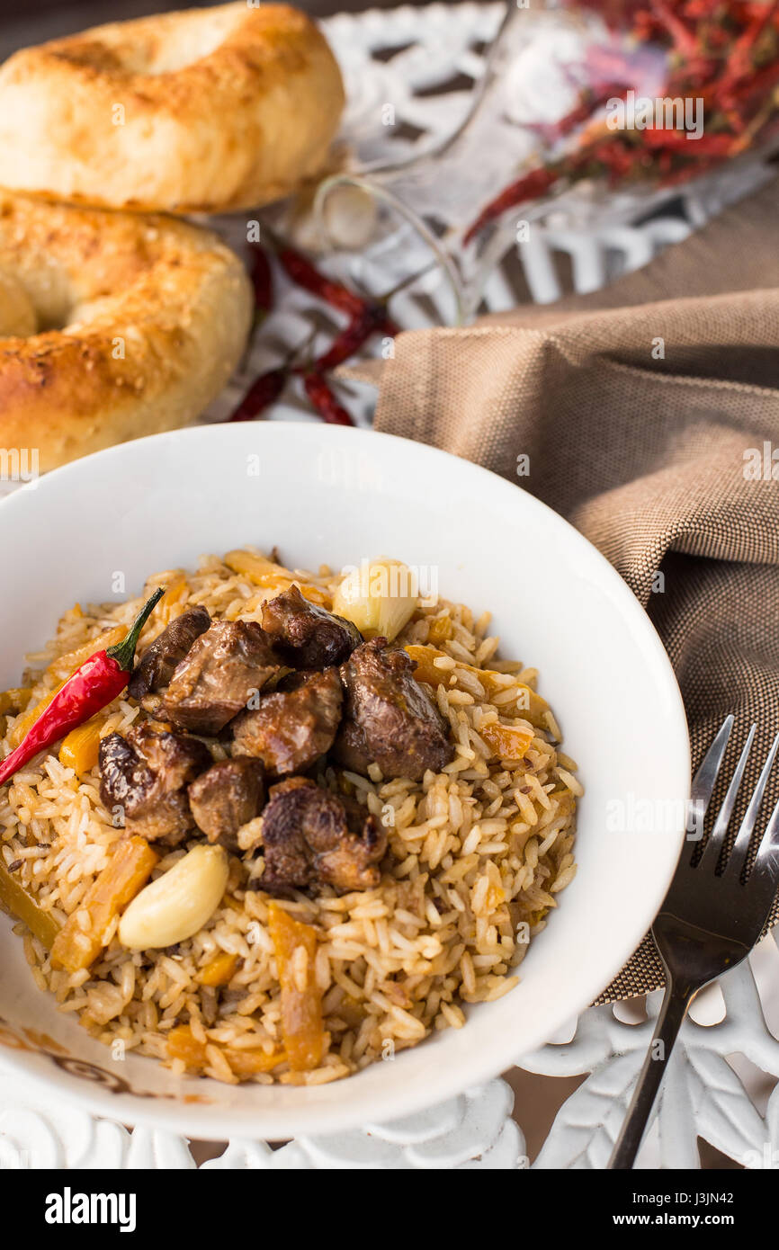 Pilaf - Rice with Meat and Vegetables on the table. Pilaf with lamb and ...