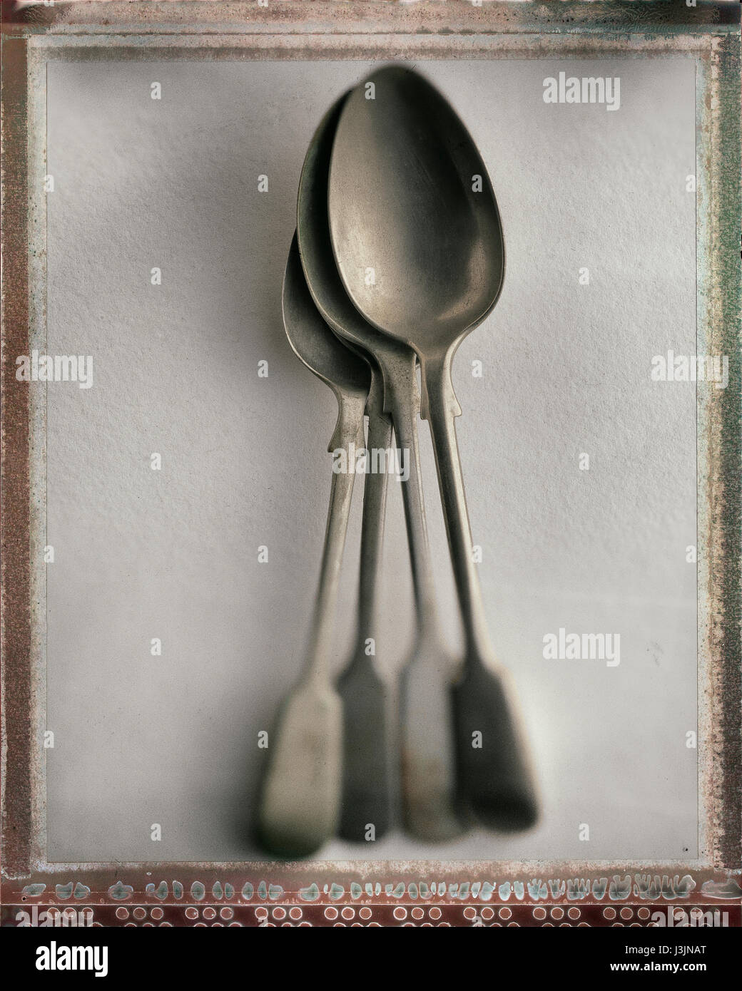 old spoons on a plain background Stock Photo - Alamy