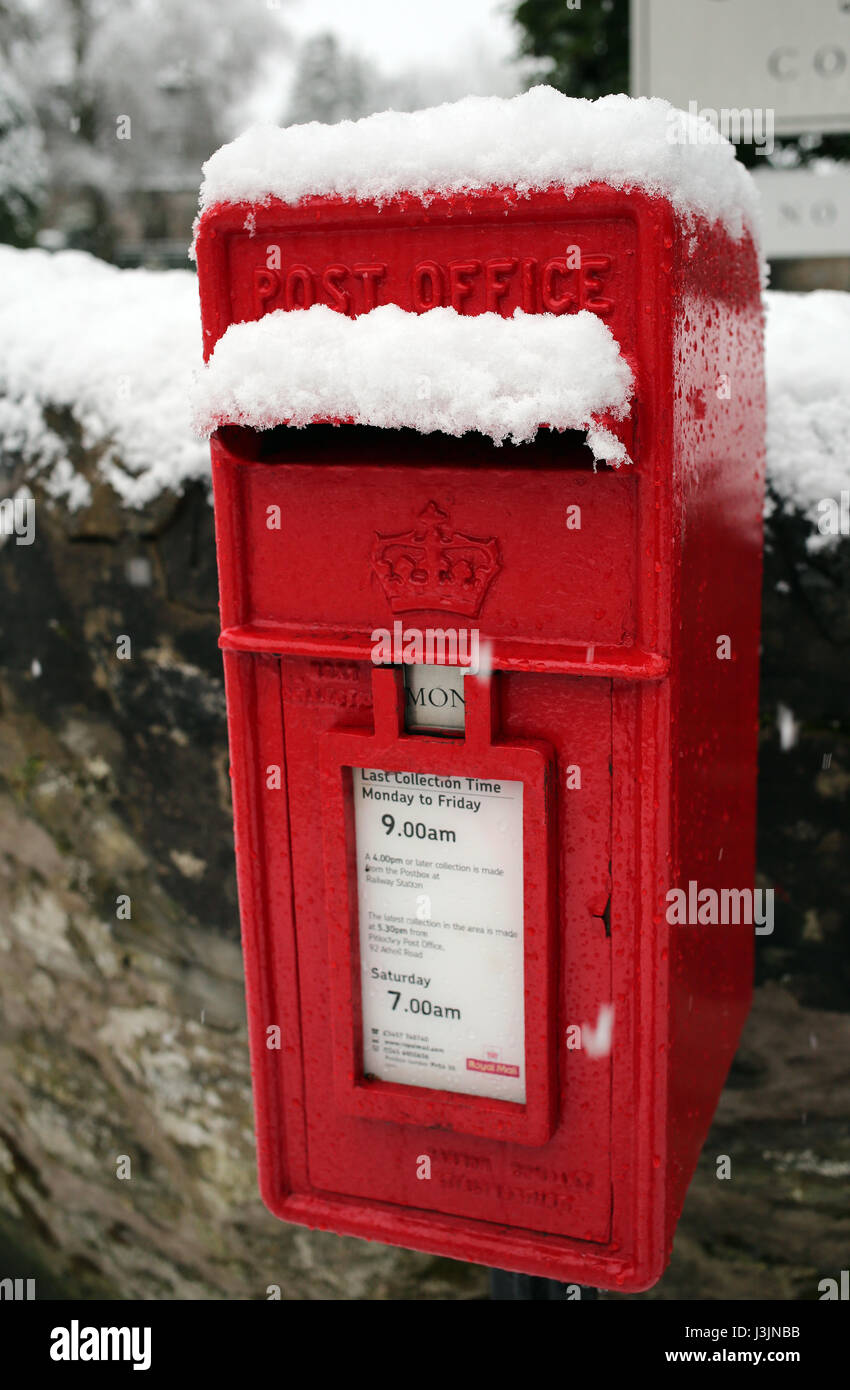 A Scottish Royal Mail postbox with the Scottish Crown in winter snow in ...