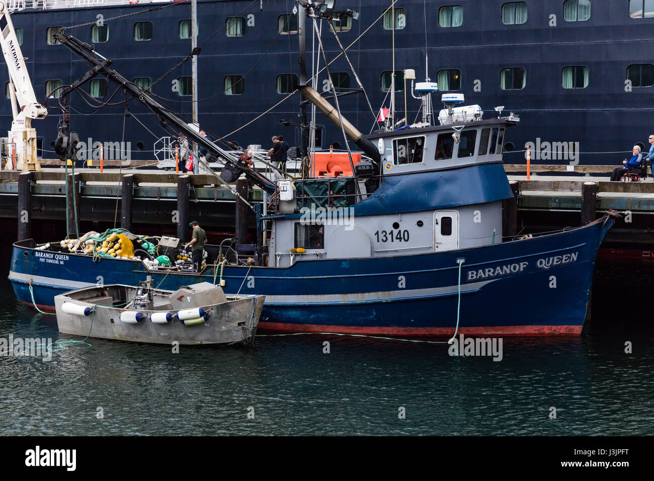 Fishing boats alongside a cruise ship in the Alaskan port of Ketchikan ...