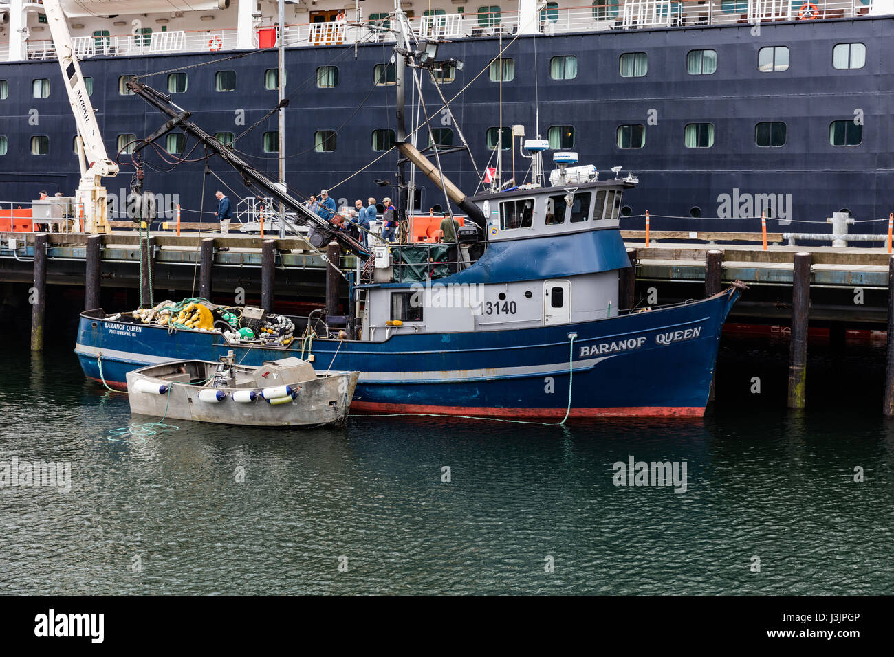 Fishing boats alongside a cruise ship in the Alaskan port of Ketchikan ...