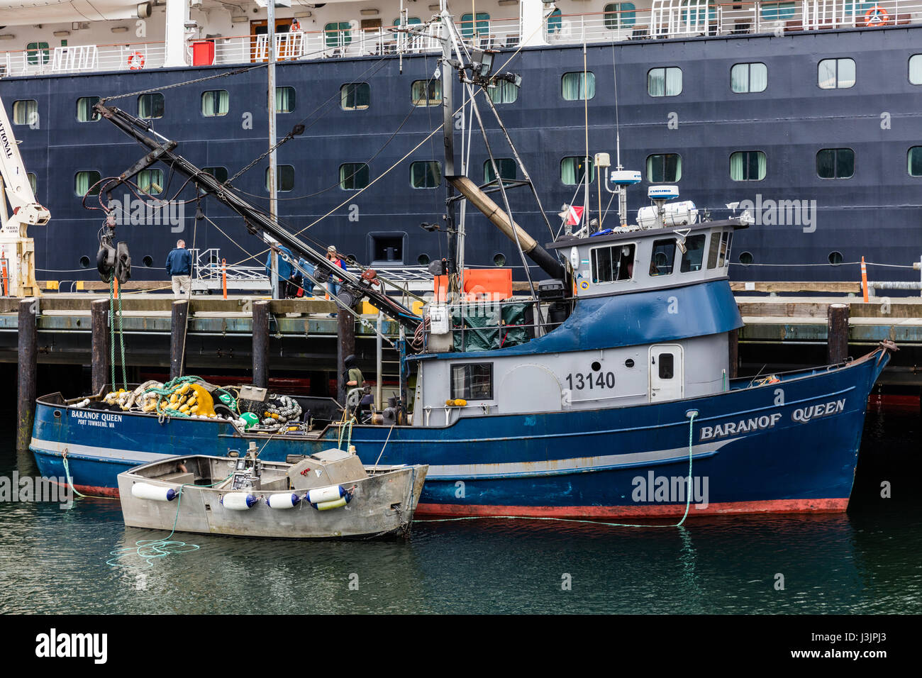 Fishing boats alongside a cruise ship in the Alaskan port of Ketchikan ...