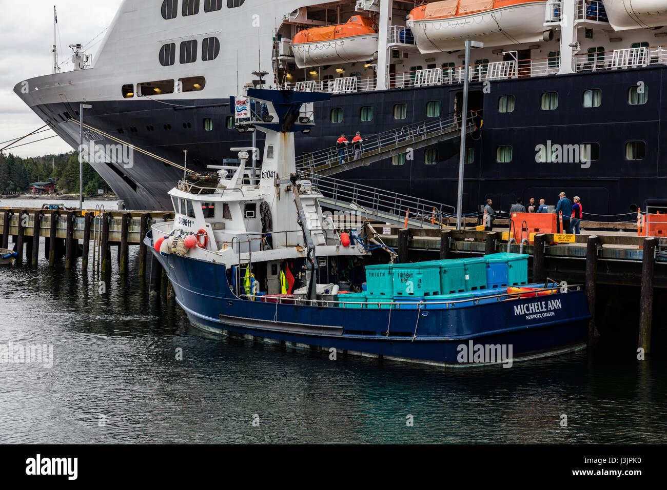 Fishing boats alongside a cruise ship in the Alaskan port of Ketchikan ...