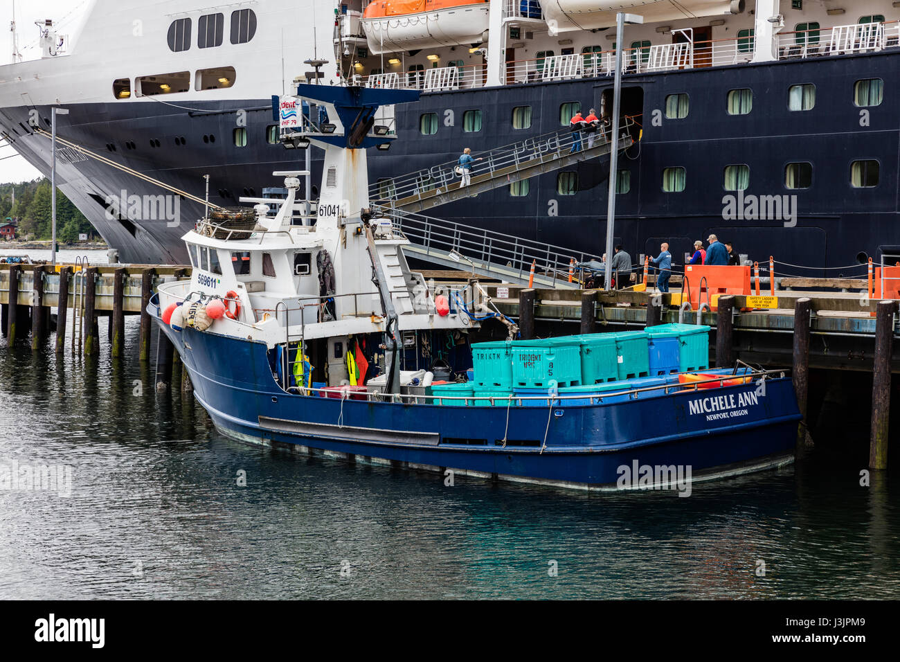 Fishing boats alongside a cruise ship in the Alaskan port of Ketchikan ...