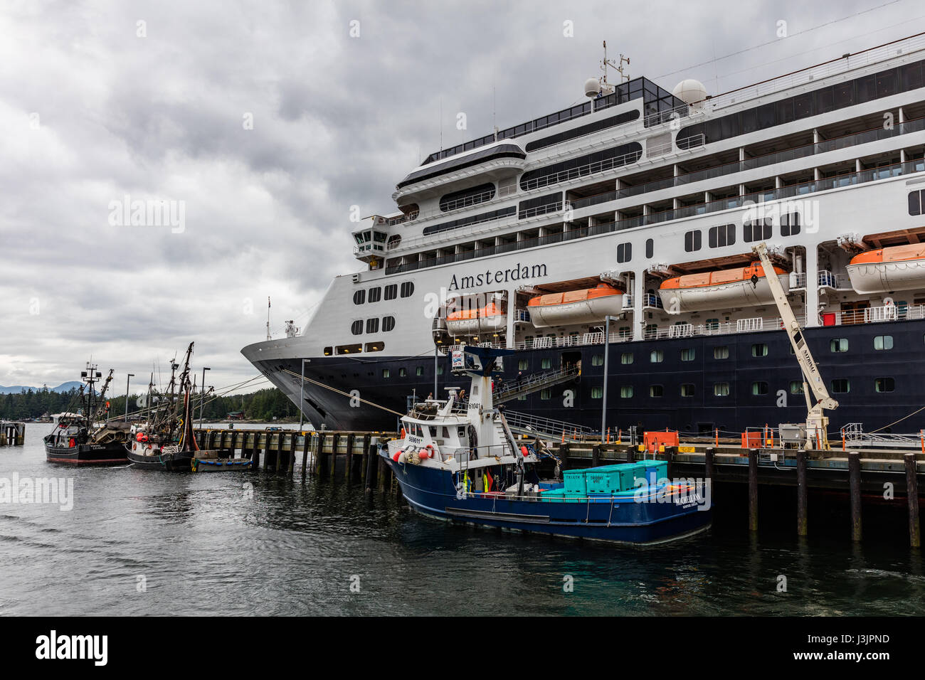 Fishing boats alongside a cruise ship in the Alaskan port of Ketchikan ...