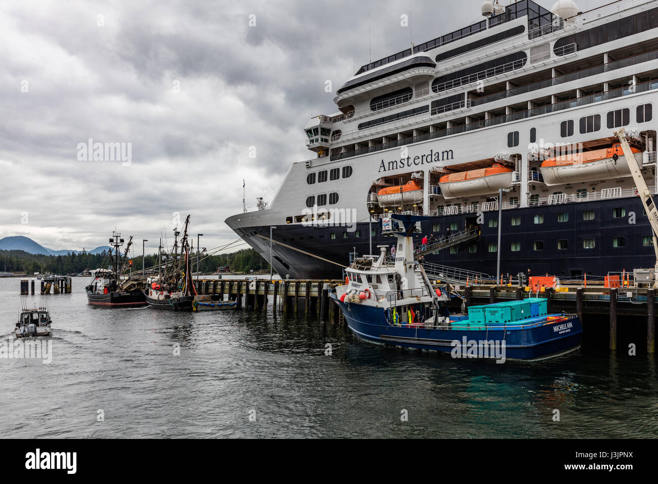 Fishing boats alongside a cruise ship in the Alaskan port of Ketchikan ...