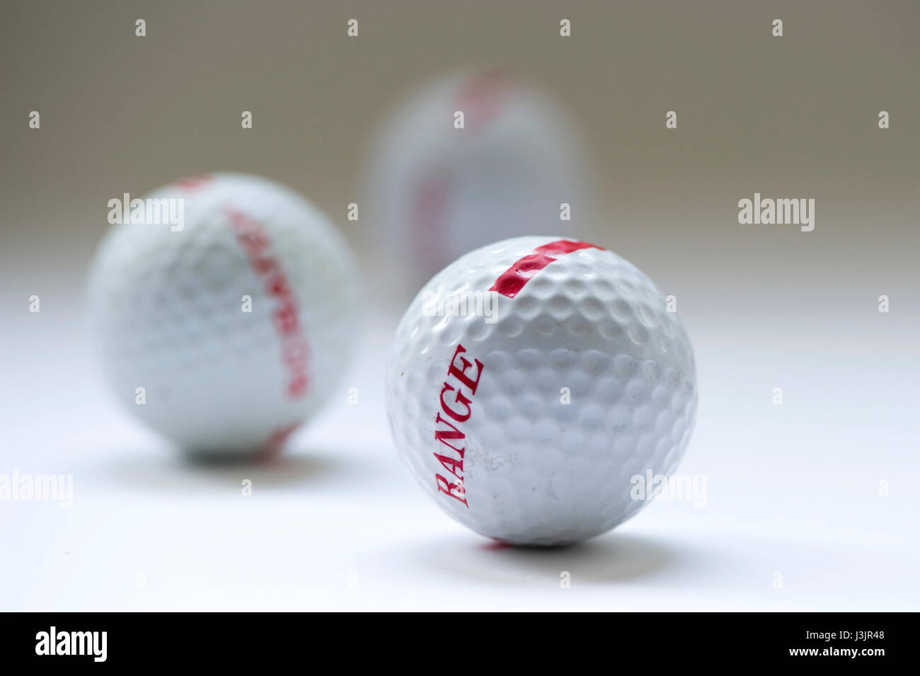 three golf balls Stock Photo - Alamy