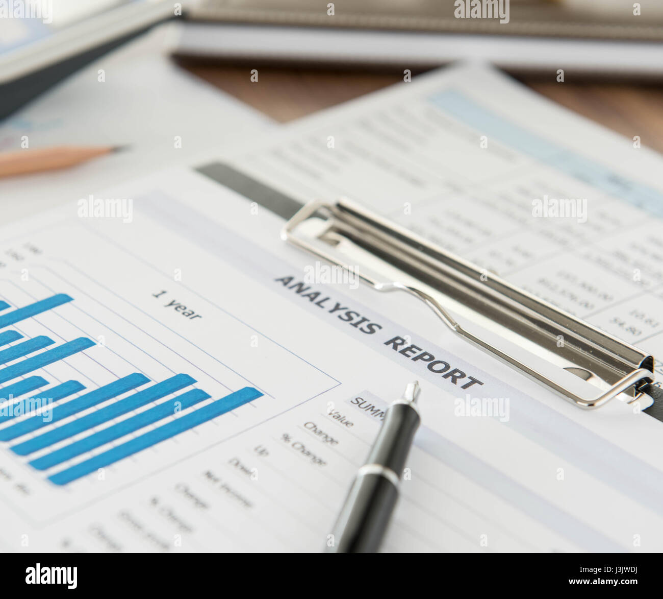 Marketer's desk with analysis Report ,Calculator, pen Stock Photo - Alamy