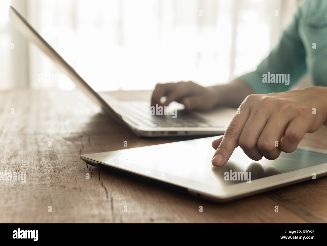 closeup a hand touch-screen tablet computer. technology concept ...