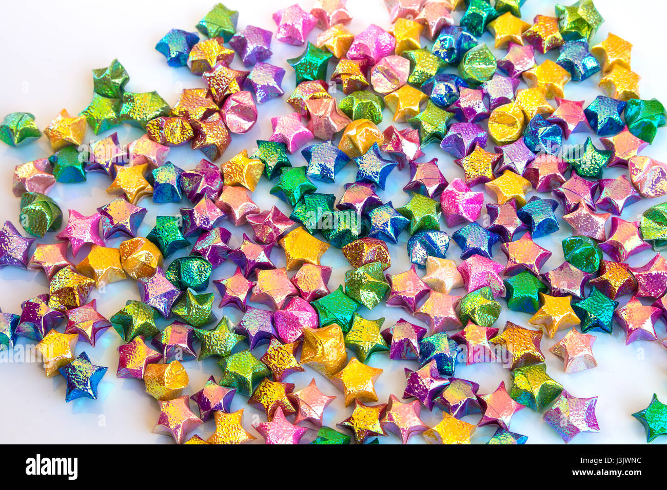 mass of colorful star paper on white background Stock Photo - Alamy