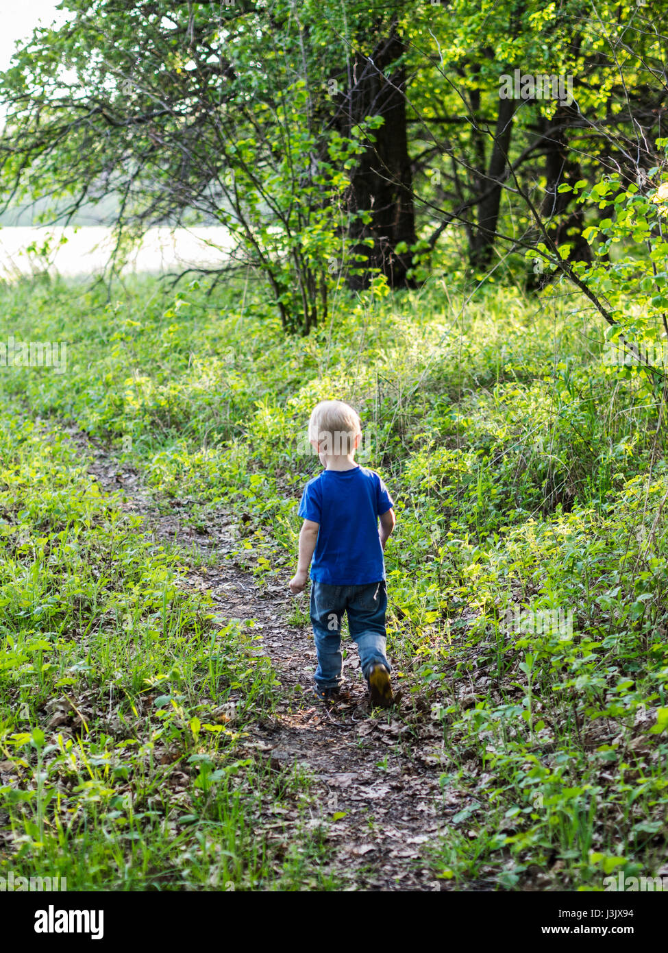 caucasian boy goes on a pathway Stock Photo - Alamy