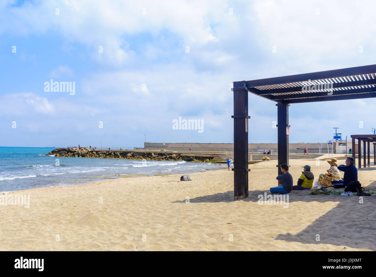 HAIFA, ISRAEL - MAY 05, 2017: Beach scene with locals, some meditating ...