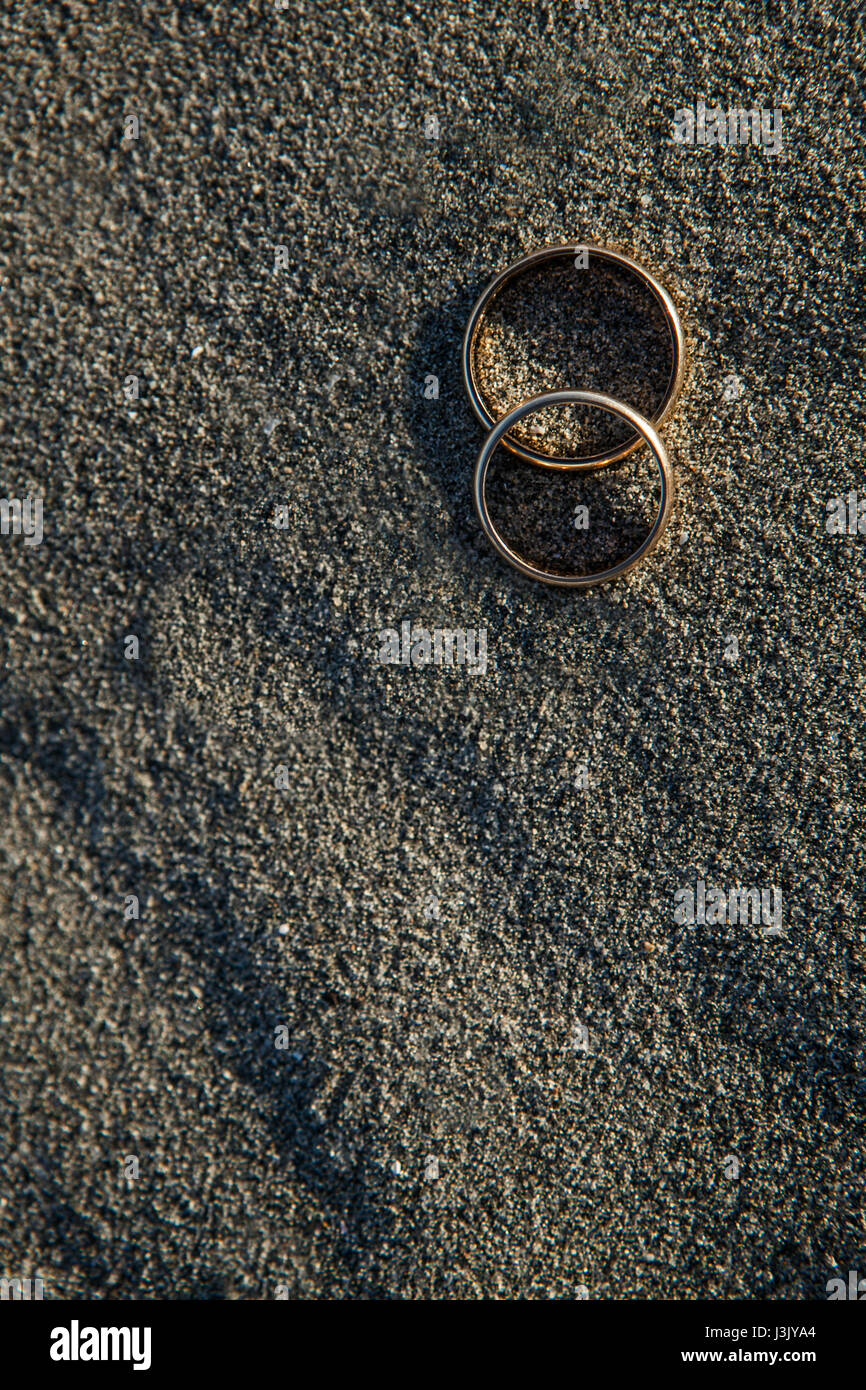 Wedding rings on the beach. Closeup view Stock Photo - Alamy
