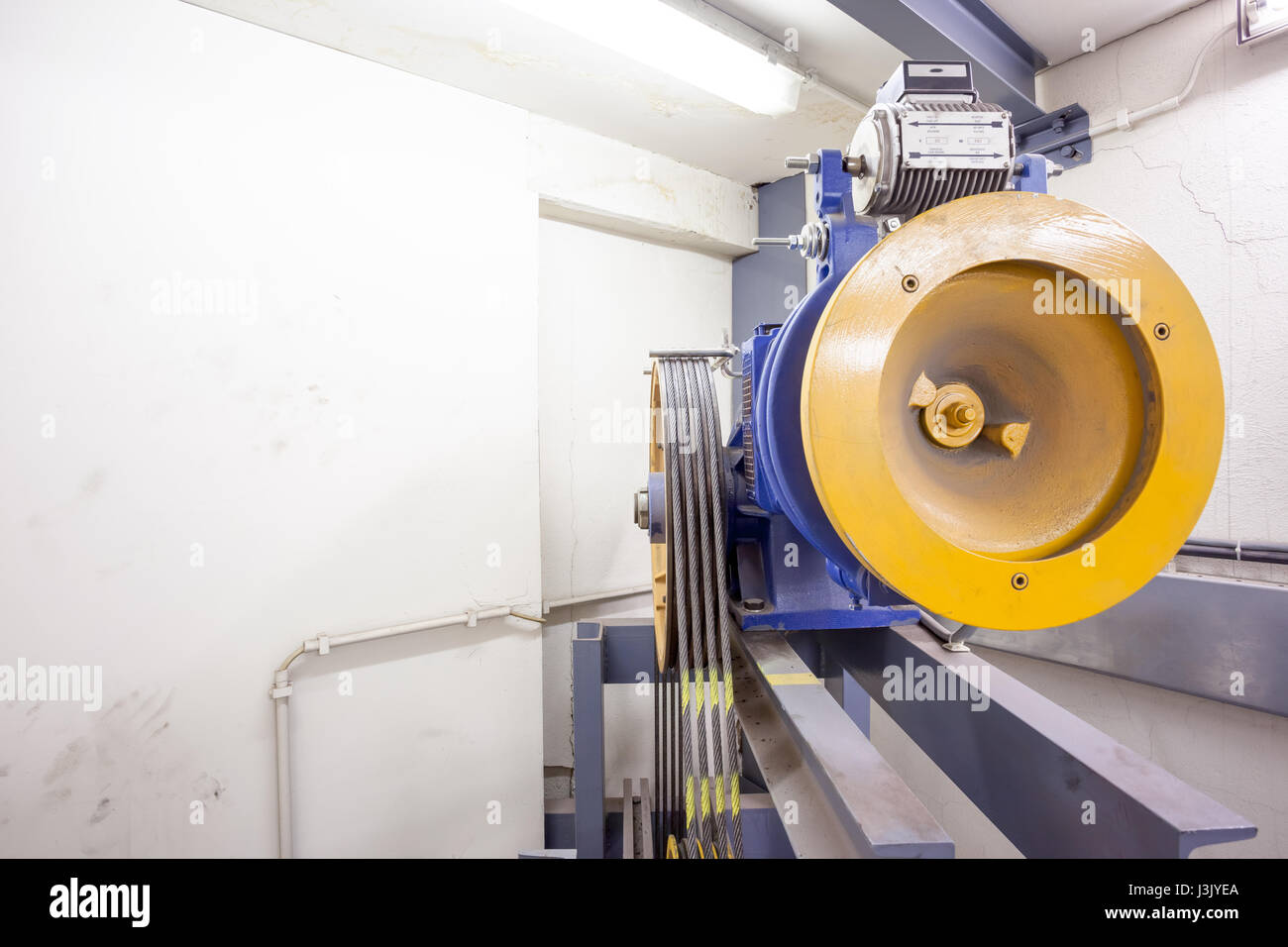iron cables on a wheel of a motor of the elevator Stock Photo - Alamy