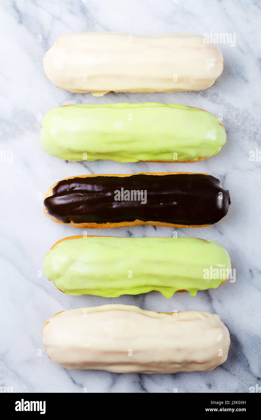 Eclair, traditional french dessert Marble background. Top view Stock ...